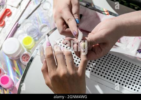 Nail extension. Treatment of the nail with a nail file, close-up Stock ...