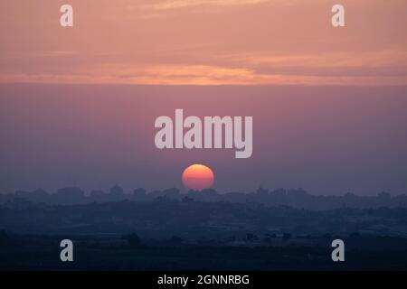 Sunset over Gaza City as it seen from Israeli side of the border with ...
