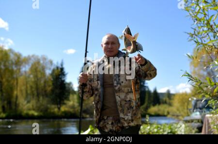 Russian President Vladimir Putin shirtless while fishing during a three ...