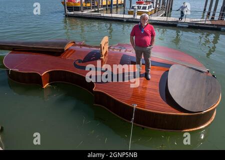 The launching of the violin-shaped boat Stock Photo - Alamy