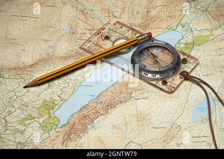 Old school navigation with paper map and digital compass outside in the ...