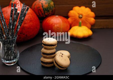 Funny colorful macaroon cookie dessert with dark background. Copy space ...