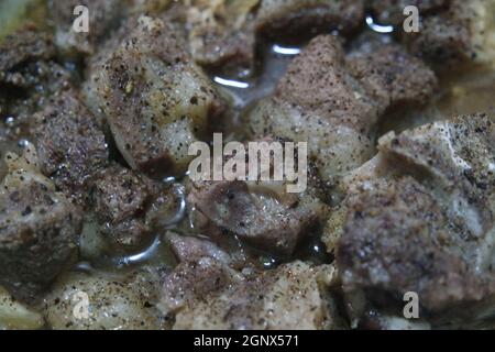 Top view of siri paaye or paya dish garnished with diced ginger, long ...