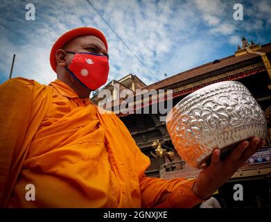 A monk wearing protective face mask walks a past skywalk amid a new ...