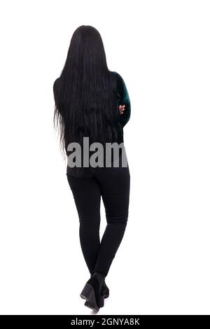 Woman posing with her back faced to camera, isolated over copy space ...