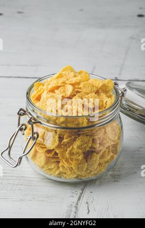 Corn flakes in a glass jar on wooden surface Stock Photo - Alamy