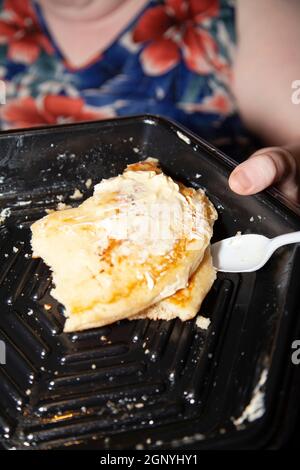 Partially eaten plain pancakes with butter and light syrup Stock Photo ...