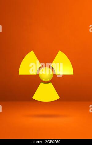 Radioactive symbol isolated on a orange studio background banner. 3D ...