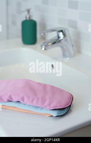 Vertical closeup of reusable menstrual/period pads soaking in water ...