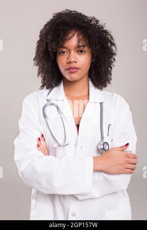 Young beautiful hispanic woman pharmacist using computer with serious ...