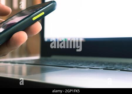 Close-up view of young professional businessman using smartphone with ...