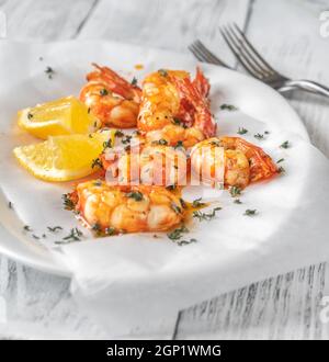 Cooked shrimps with thyme and lemon wedges on serving plate Stock Photo ...
