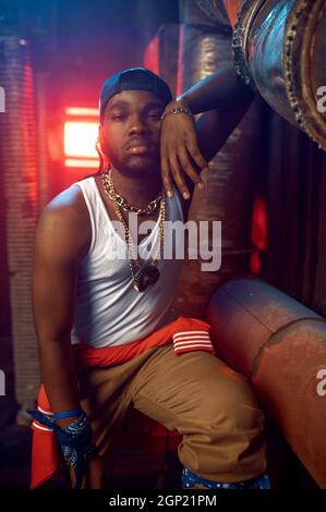 Stylish rapper in hoodie poses in grunge studio Stock Photo - Alamy