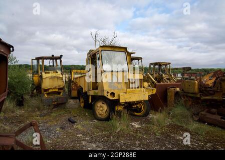 Abandoned construction vehicles parked up on a disused runway in ...