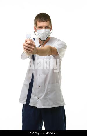 Masked doctor holding head of phonendoscope in front of him, isolated ...