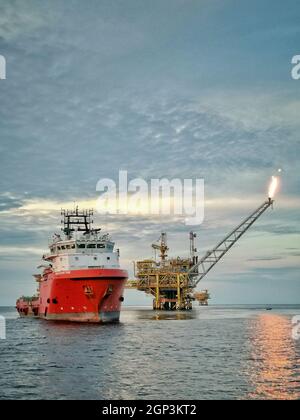 offshore support vessel stand by near oil platform at sea Stock Photo ...