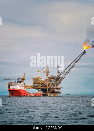 offshore support vessel stand by near oil platform at sea Stock Photo ...