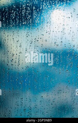 heavy rain drops on blue window Stock Photo - Alamy