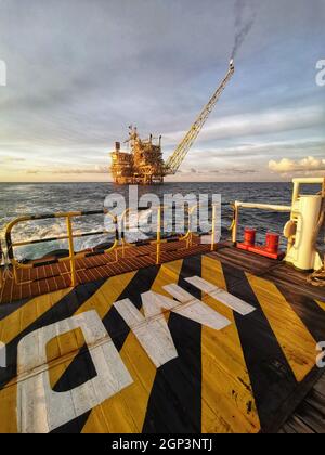 offshore support vessel stand by near oil platform at sea Stock Photo ...