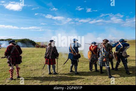 Jacobite soldiers in period costume fire guns in re-enactment of Battle ...
