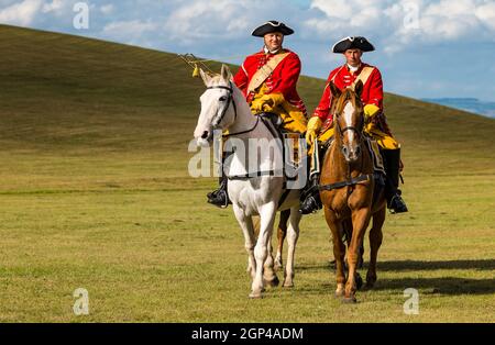 Historical reenactment of U S cavalry on horseback with American flag ...
