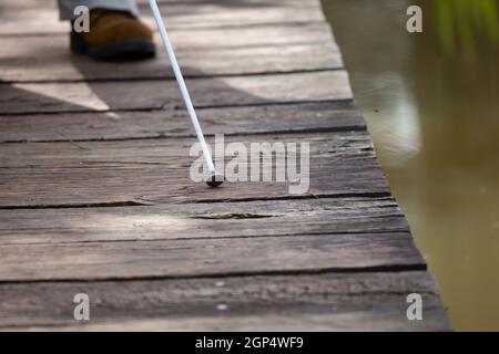Blind woman standing on a bridge over water Stock Photo - Alamy