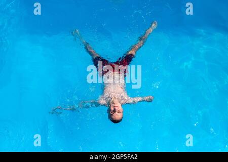 Man chilling in the swimming pool Stock Photo - Alamy
