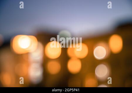 Blurry apartment block at dusk, urban city life, lights Stock Photo - Alamy