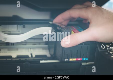 Putting new printer cartridge into the printer, inkjet Stock Photo - Alamy