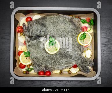 Cooked Whole Turbot fish in baking pan oven with potatoes, bell pepper ...