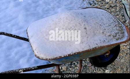 snow on a wheelbarrow in wintertime Stock Photo - Alamy