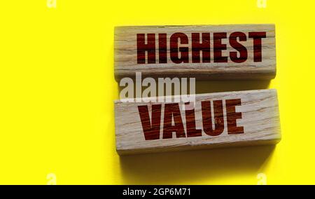 Highest values words on wooden building blocks isolated on yellow ...