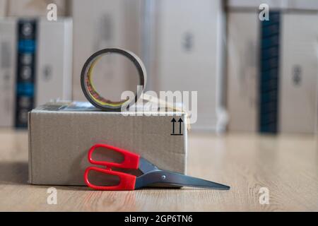Shipping concept: Cardboard box, scissors and sticky tape Stock Photo ...