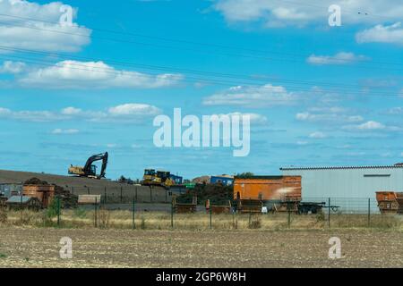 Rusty plastic waste container, air conditioners and fruits shop in ...