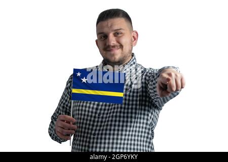 White guy holding a flag of Curacao and points forward in front of him ...