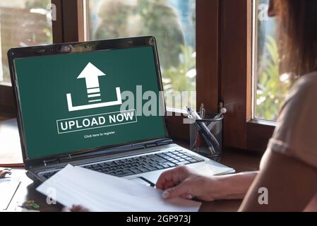 Laptop screen displaying an upload concept Stock Photo - Alamy