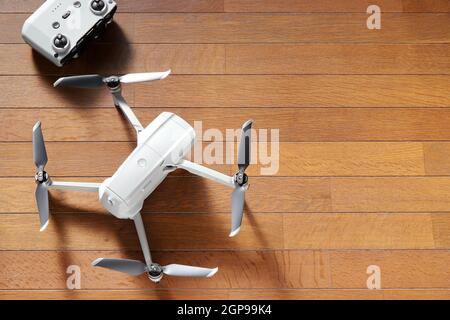 small drone copter with controller on a wooden background Stock Photo ...