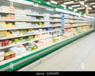 Abstract blur supermarket aisle with can food and snack product on ...