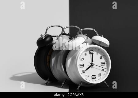 row of alarm clocks on white background Stock Photo - Alamy