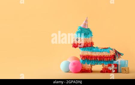 Mexican pinata with party hat, gifts, maracas and confetti on green ...