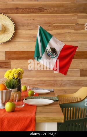 Mexican flag and dining table near wooden wall Stock Photo - Alamy