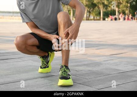 Young man scratching himself outdoors Stock Photo - Alamy