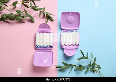 Tampons storage boxes on blue and pink background, top view Stock Photo ...