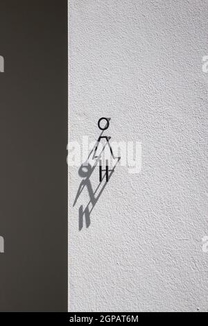 Modern sign shadow of outdoor toilet Stock Photo - Alamy