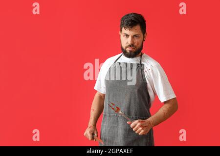 Man dressed as butcher for Halloween on blue background with space for ...