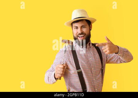Handsome man in traditional German clothes and with beer on green ...