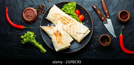 Chicken shawarma made from roasted meat wrapped in pita bread.Doner ...