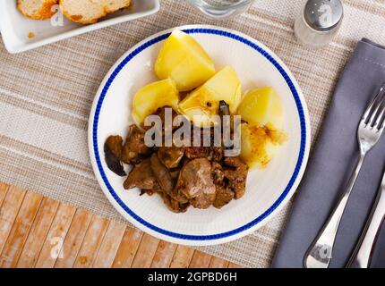 Fried rabbit liver served with boiled potato Stock Photo - Alamy