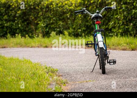 Child's bike rear view standing on the road Stock Photo - Alamy
