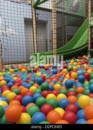 Children playground with slides and colorful balls in the sand outdoor ...